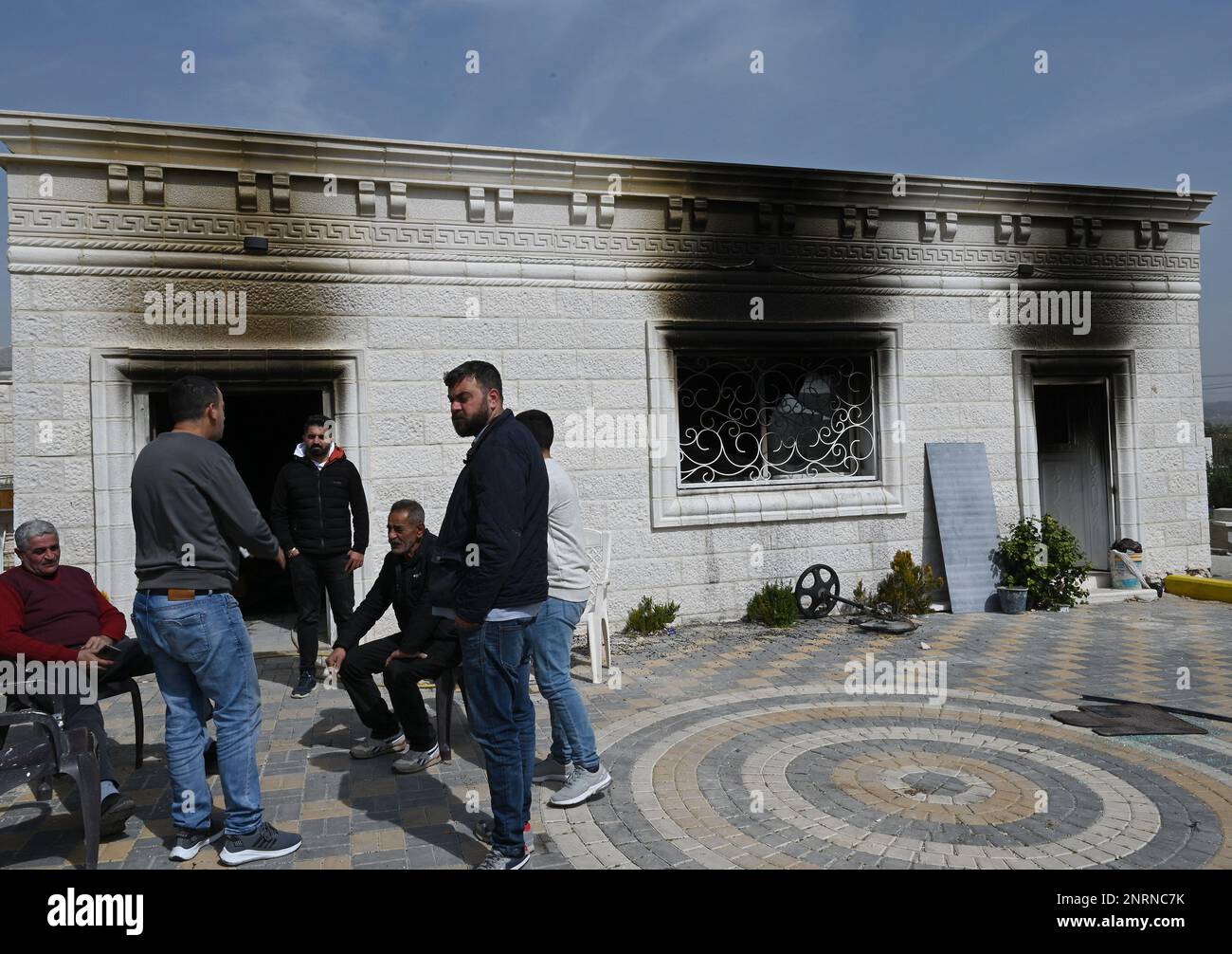 Hawara, Gaza. 27th Feb, 2023. Palestinian stand outside a house burned ...