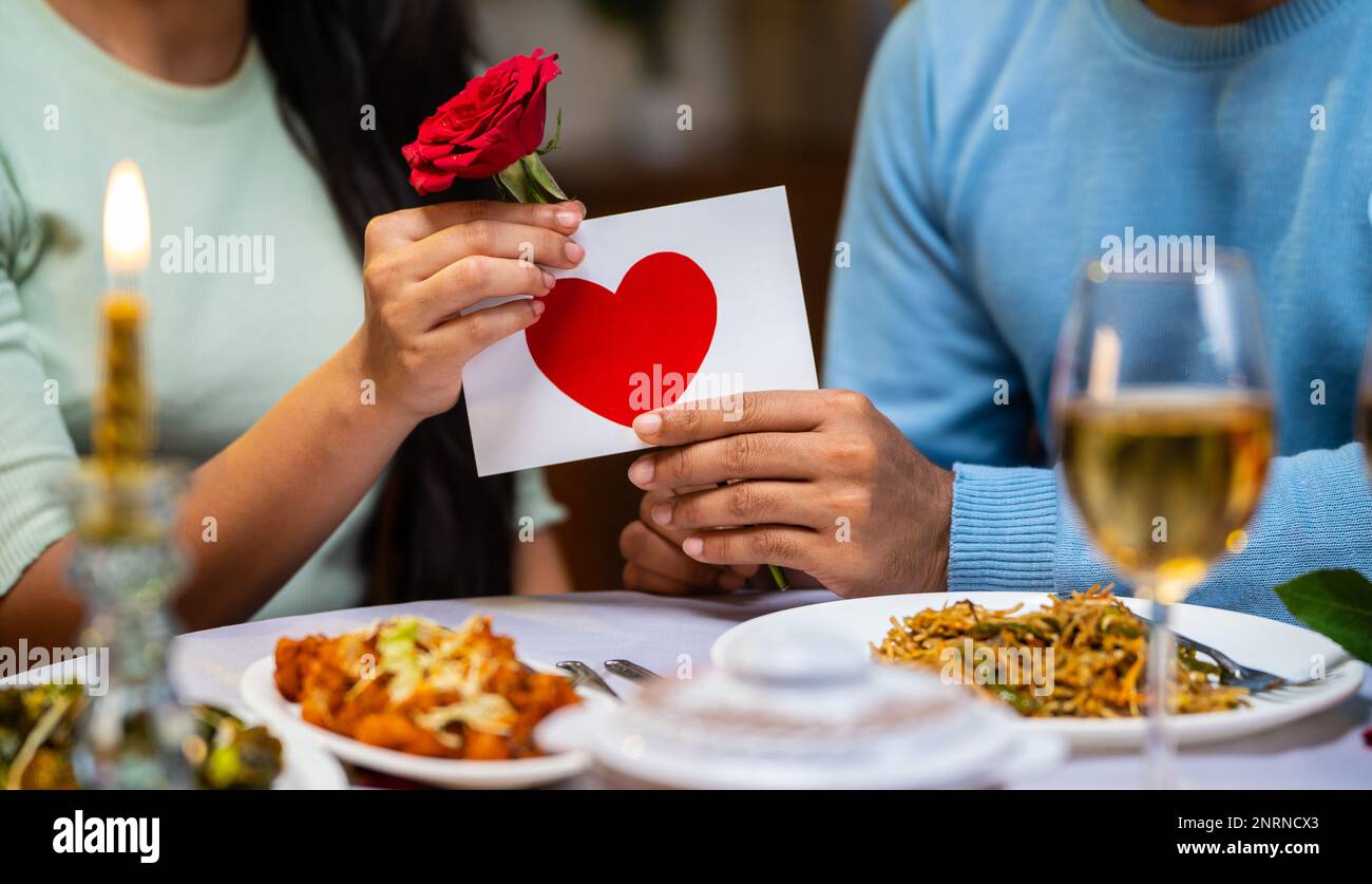 close up shot of girl hands accepting roses with greeting by boyfriend ...