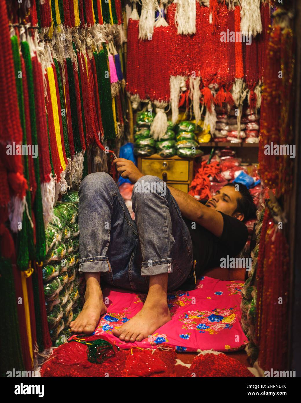 Kathmandu, Nepal, 04 23 2022: A webster lying in his booth in Kathmandu ...