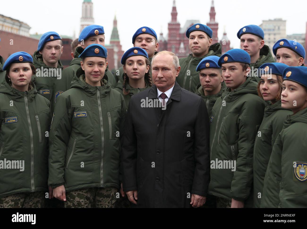 Russian President Vladimir Putin poses for a picture with members of ...
