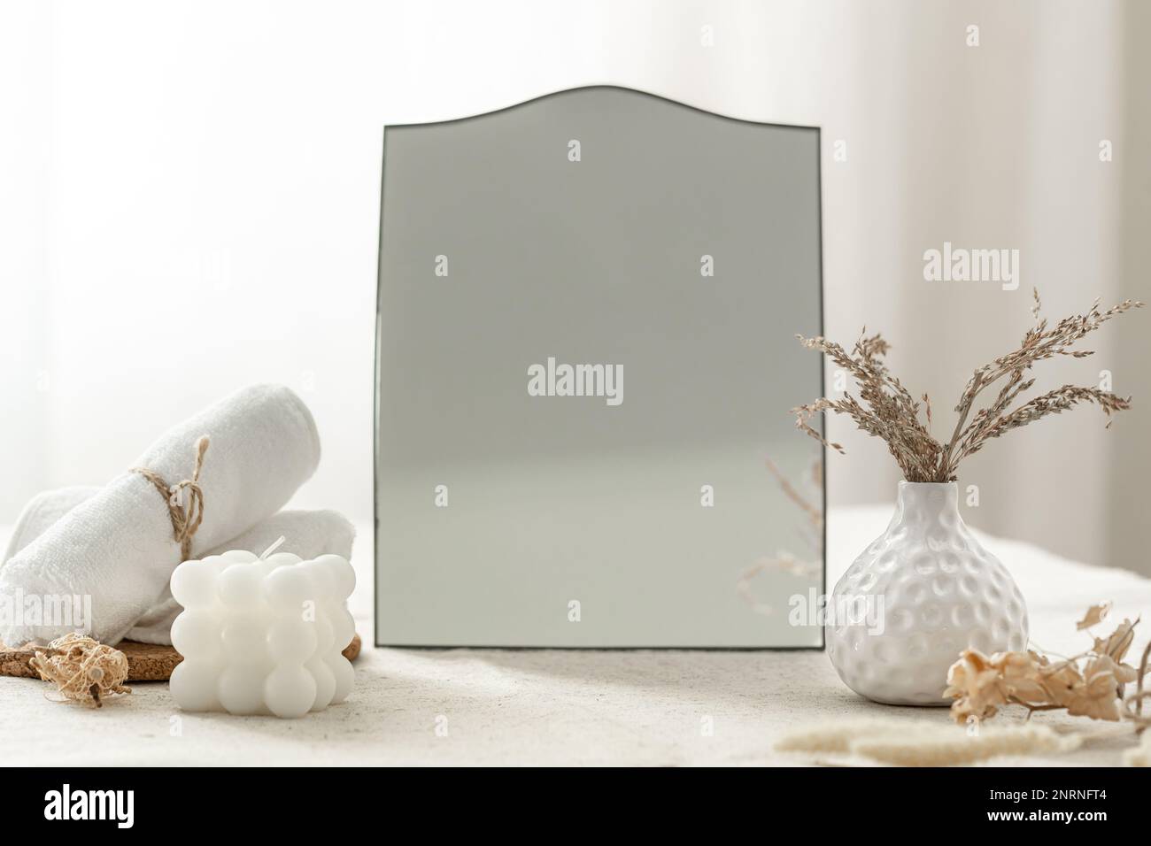 A cozy composition with a mirror and decorative details in a bright ...