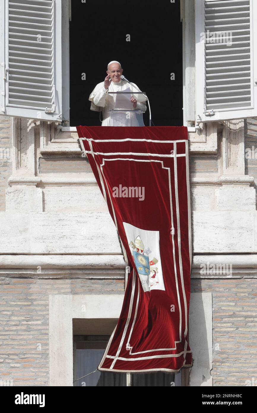 Pope Francis waves during the Angelus noon prayer he delivers from his ...