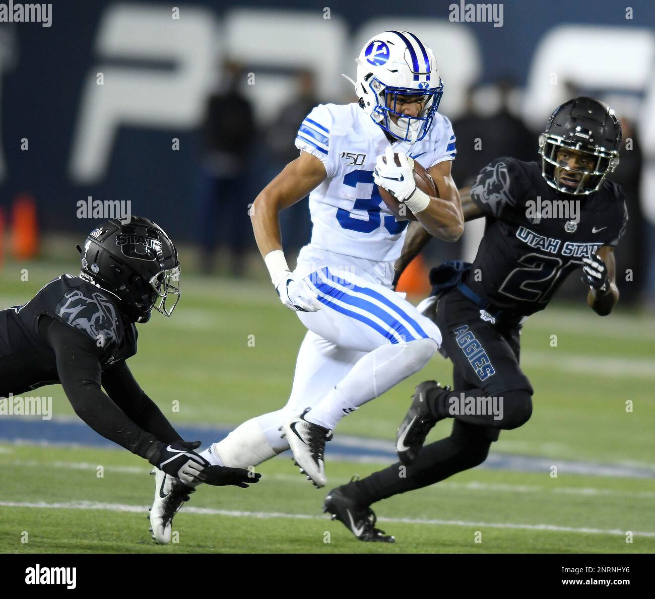 BYU running back Sione Finau (35) carries the ball as Utah State safety ...