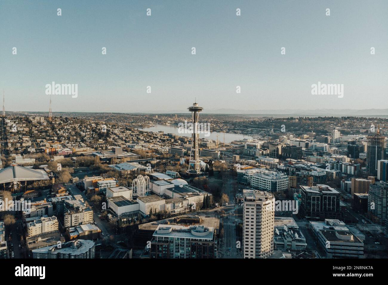 An aerial view of the Space Needle Tower surrounded by buildings in ...