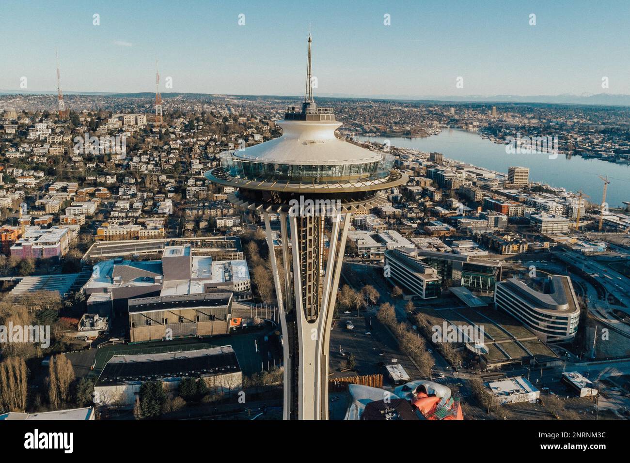 An aerial view of the Space Needle Tower surrounded by buildings in ...