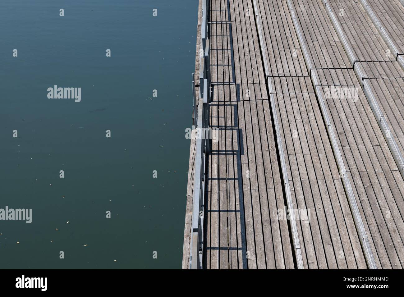 Wooden boardwalk with steps at river bay waterfront, view from above ...