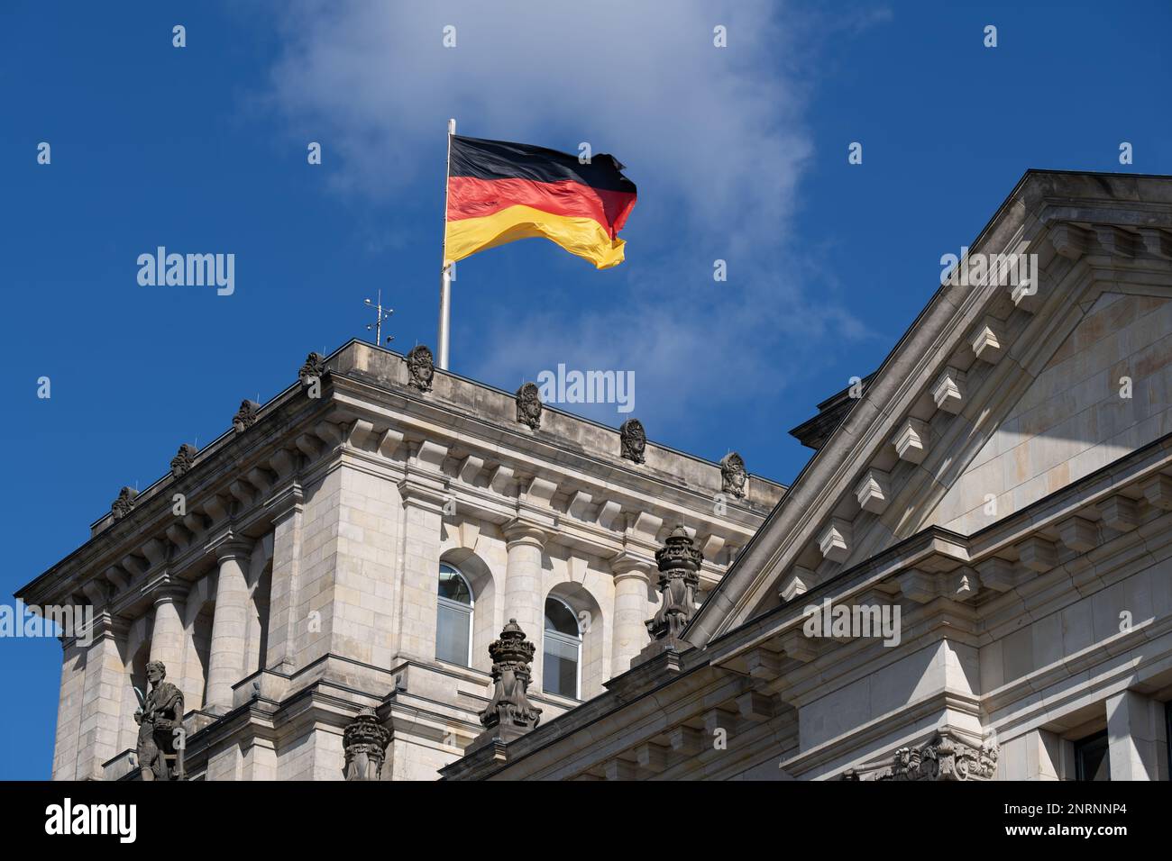 National flag of Germany in the wind and Reichstag building ...