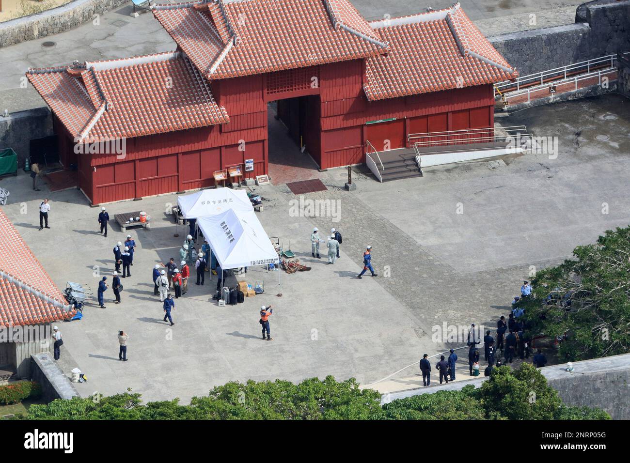 An aerial photo shows local police officers and firefighters inspecting ...