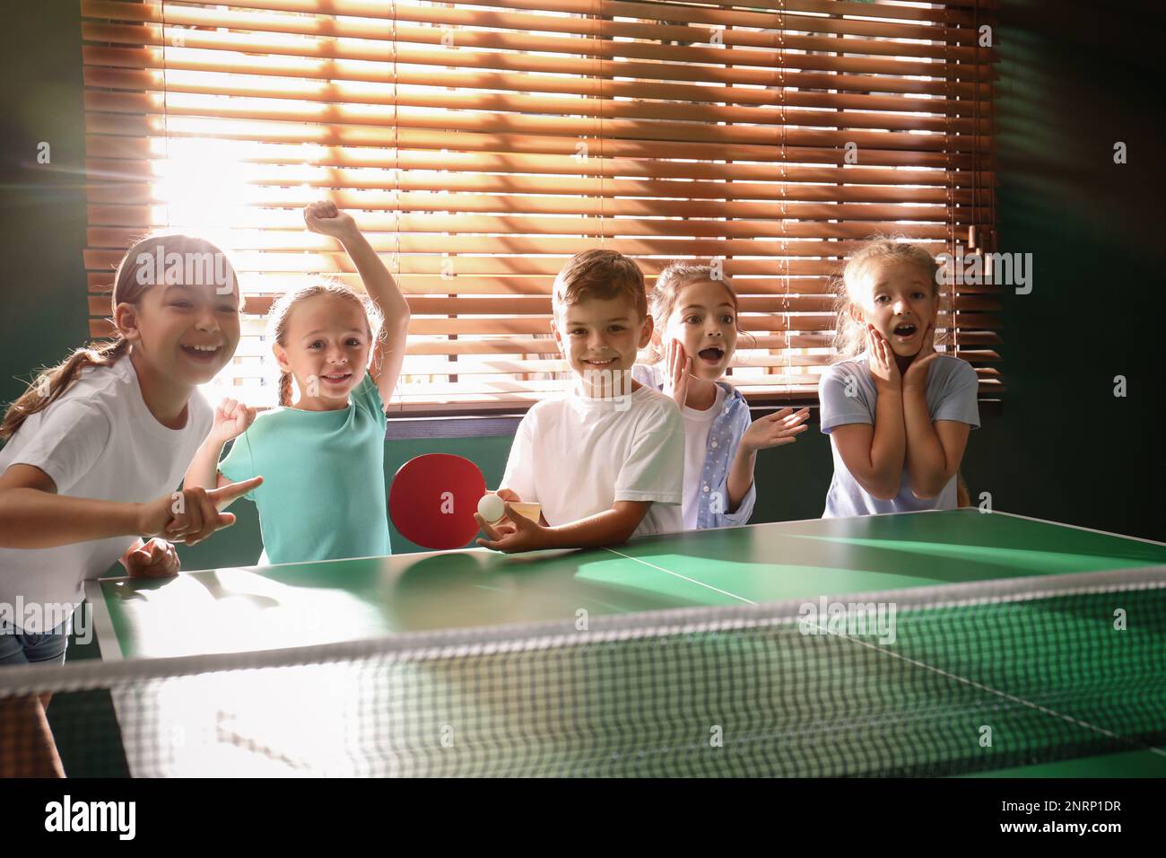 Cute happy children playing ping pong indoors Stock Photo - Alamy