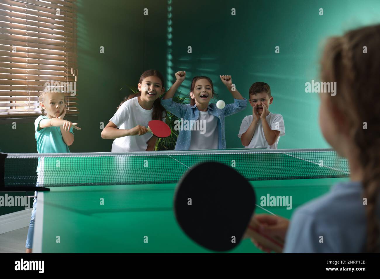 Cute happy children playing ping pong indoors Stock Photo - Alamy