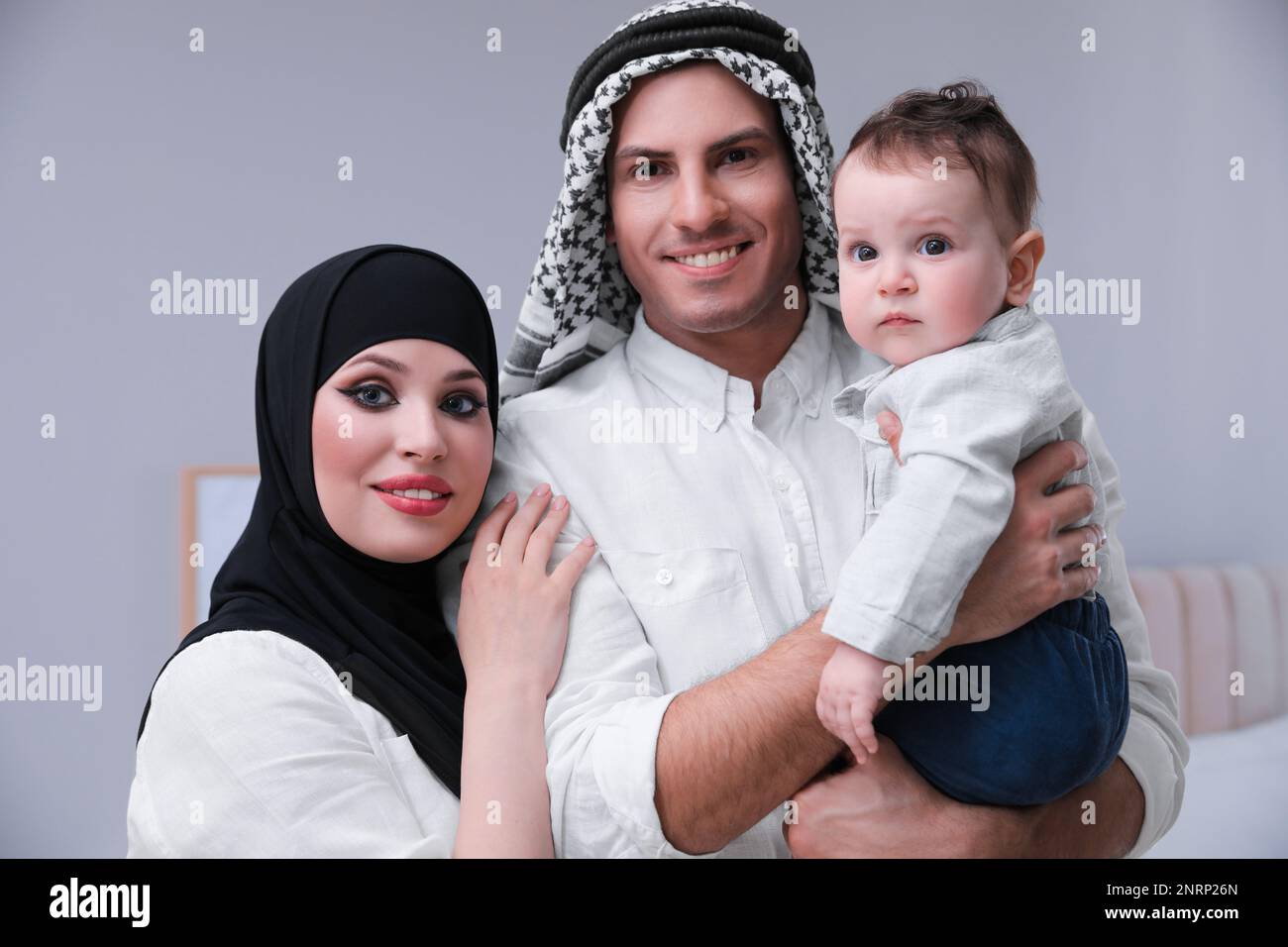 Happy Muslim family with little son in bedroom Stock Photo - Alamy