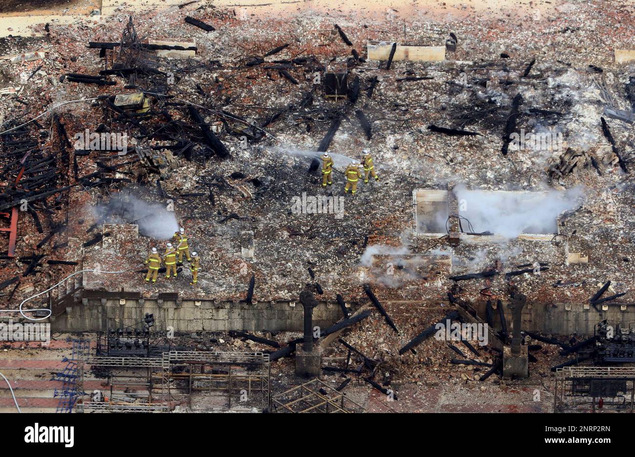 An aerial photo shows firefighters extinguishing smoldering at Seiden ...