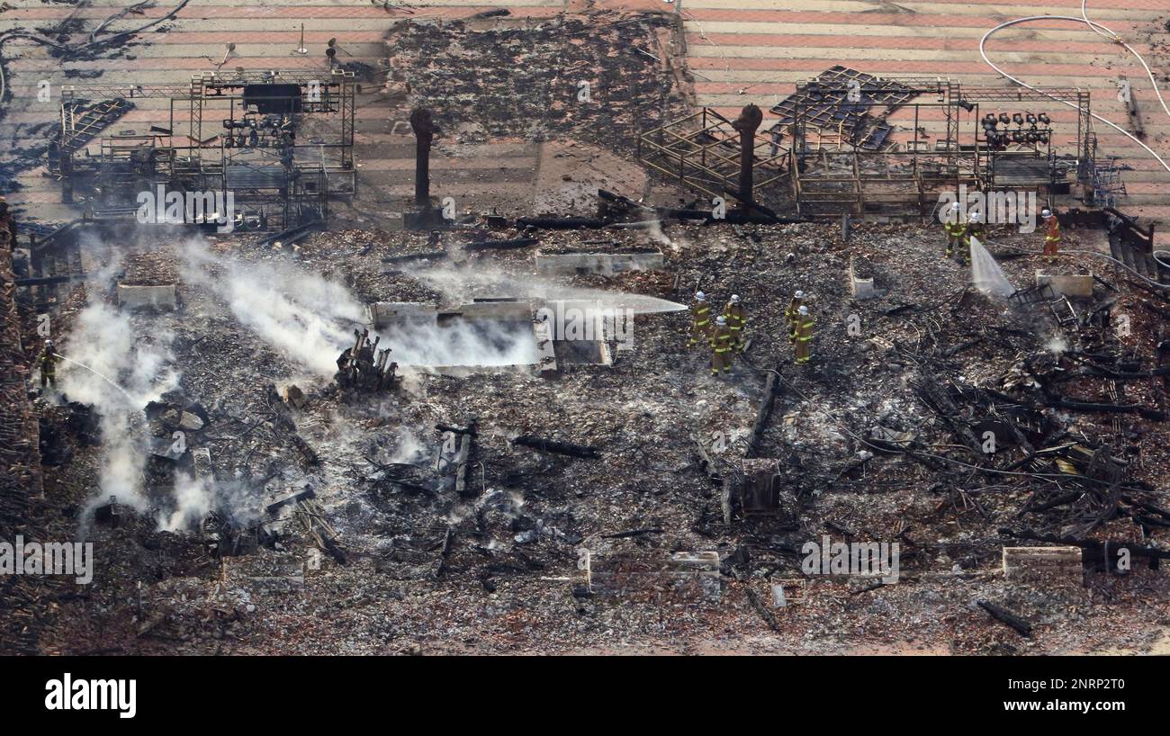 An aerial photo shows firefighters extinguishing smoldering at Seiden ...