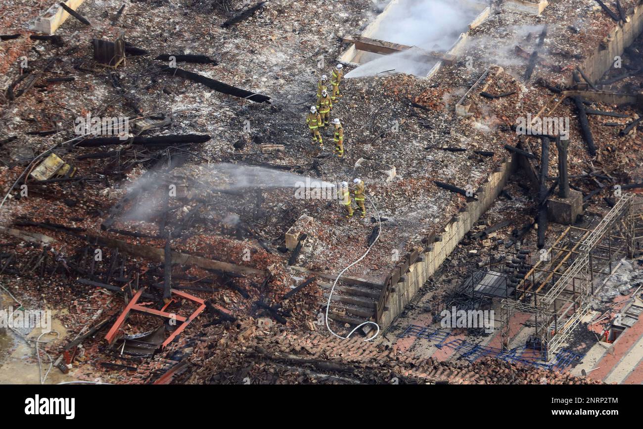 An aerial photo shows firefighters extinguishing smoldering at Seiden ...
