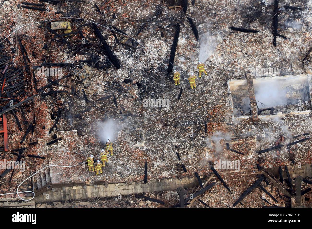An aerial photo shows firefighters extinguishing smoldering at Seiden ...