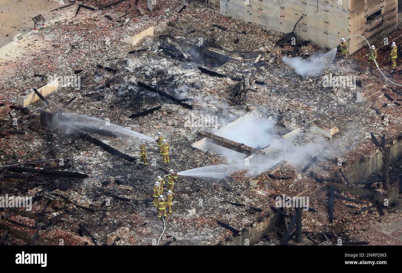 An aerial photo shows firefighters extinguishing smoldering at Seiden ...