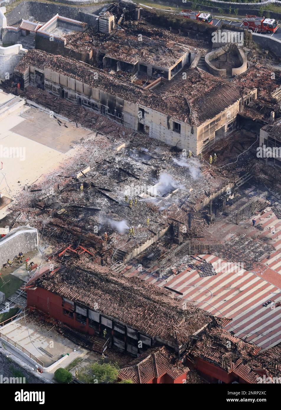 An aerial photo shows firefighters extinguishing smoldering at Seiden ...