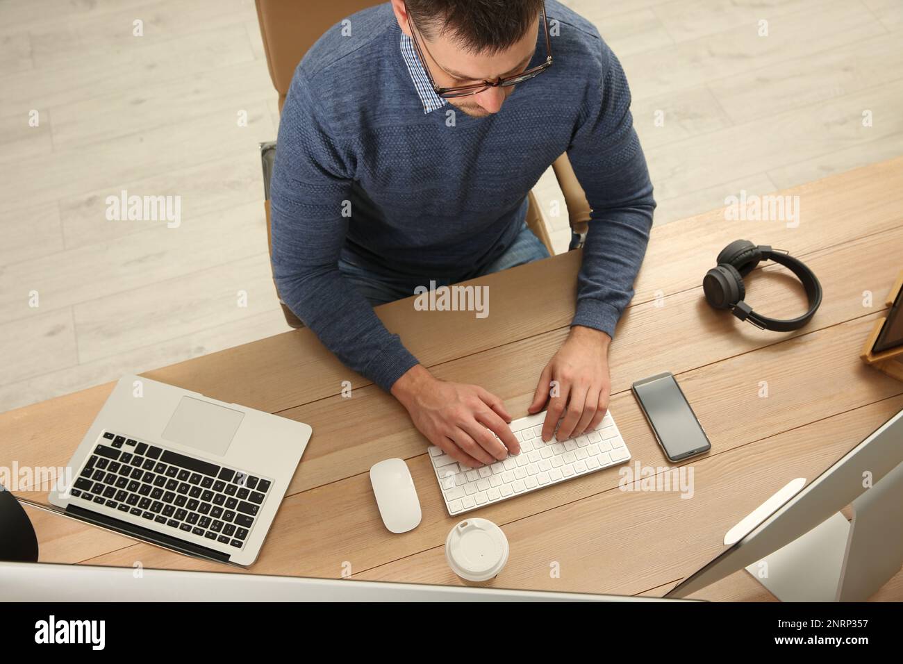 Programmer working at desk in office, top view Stock Photo - Alamy