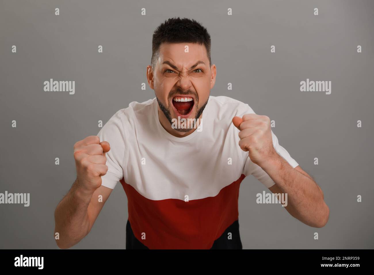 Angry man yelling on grey background. Hate concept Stock Photo - Alamy