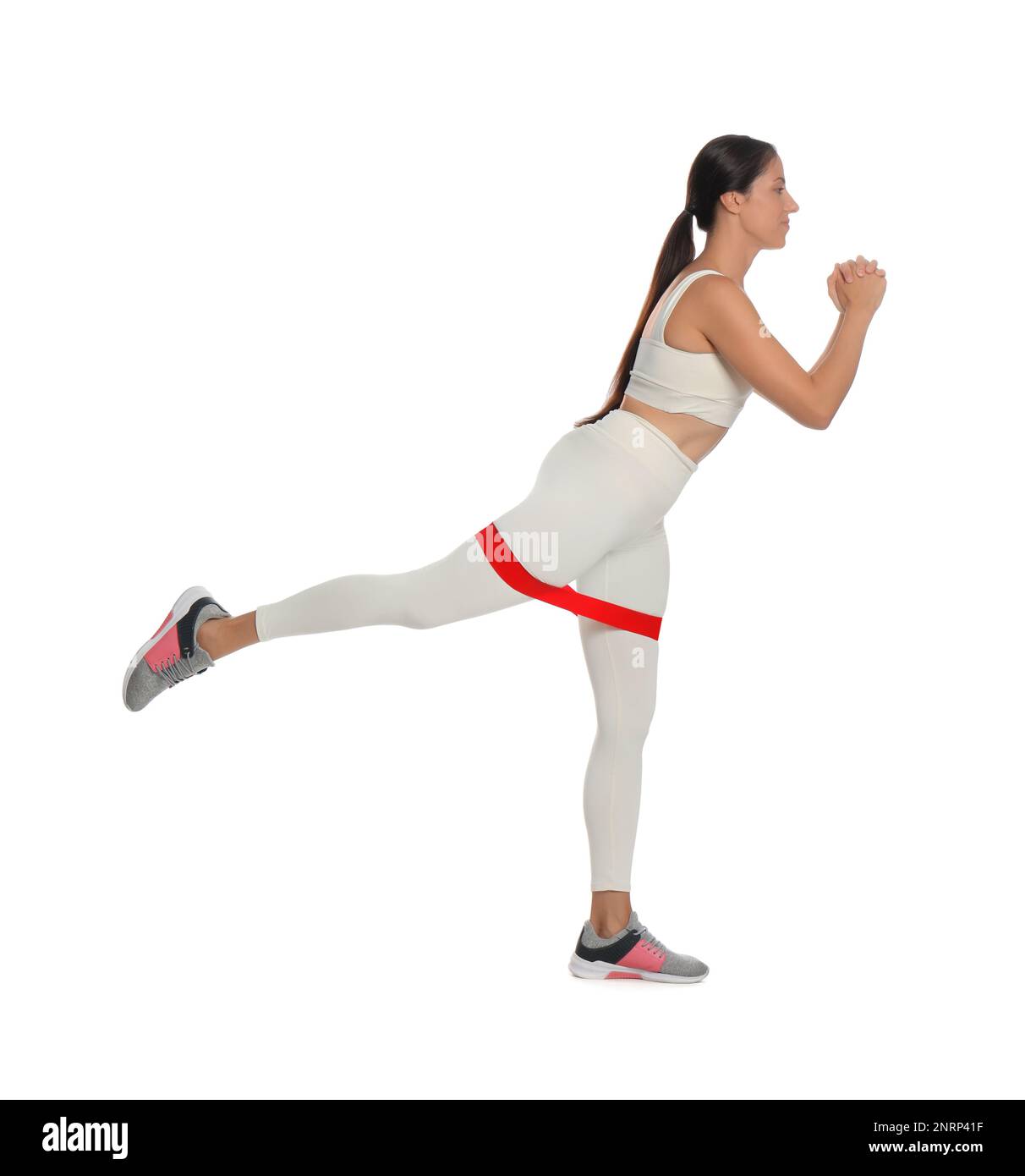 Woman doing sportive exercise with fitness elastic band on white ...