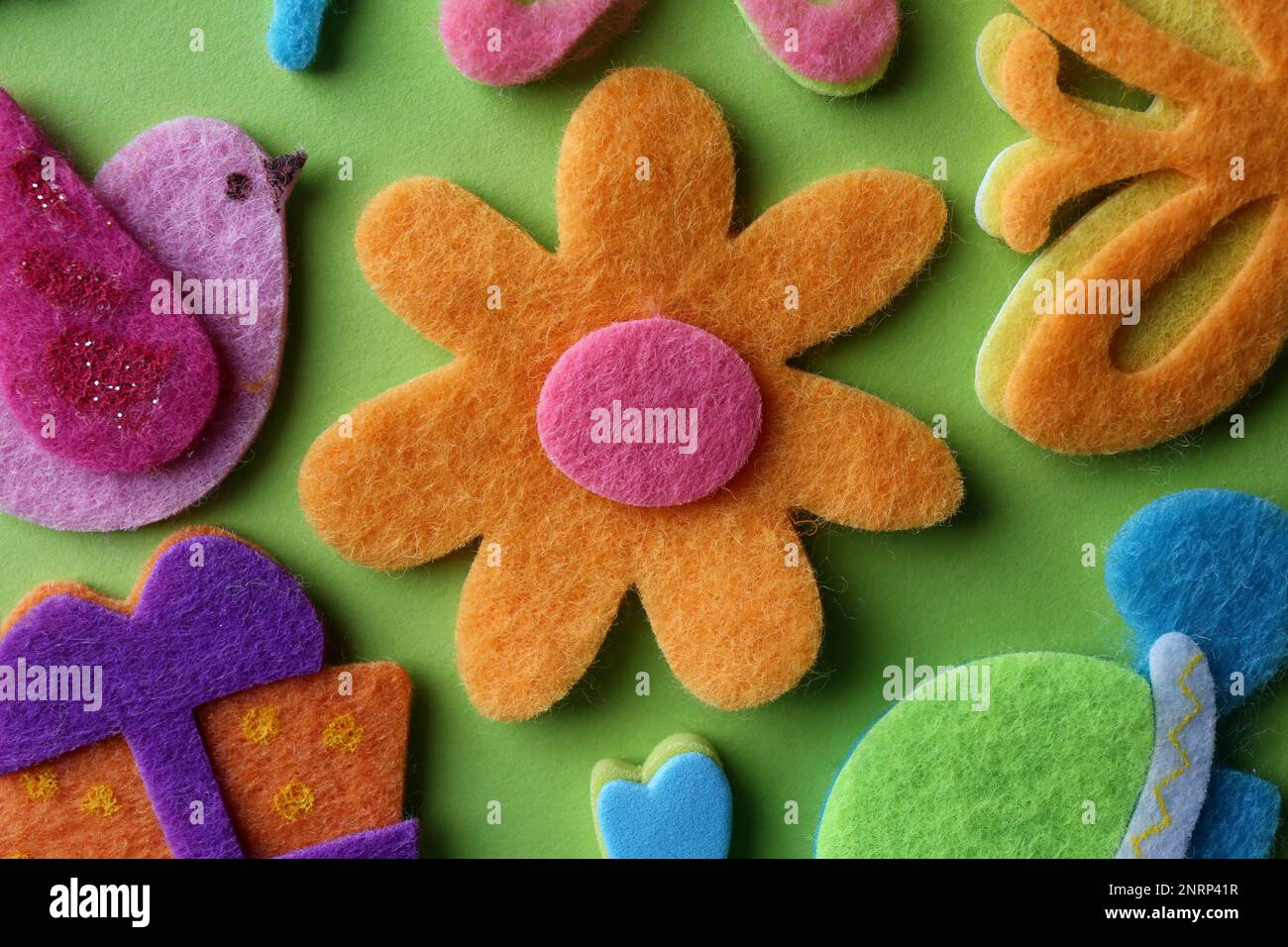 Different small colorful felt items on green background, flat lay Stock ...