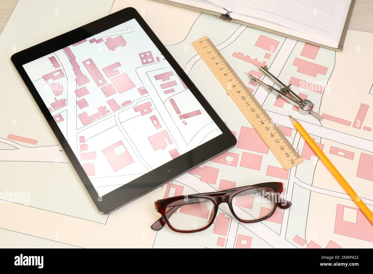 Office stationery, tablet and cadastral maps of territory with ...