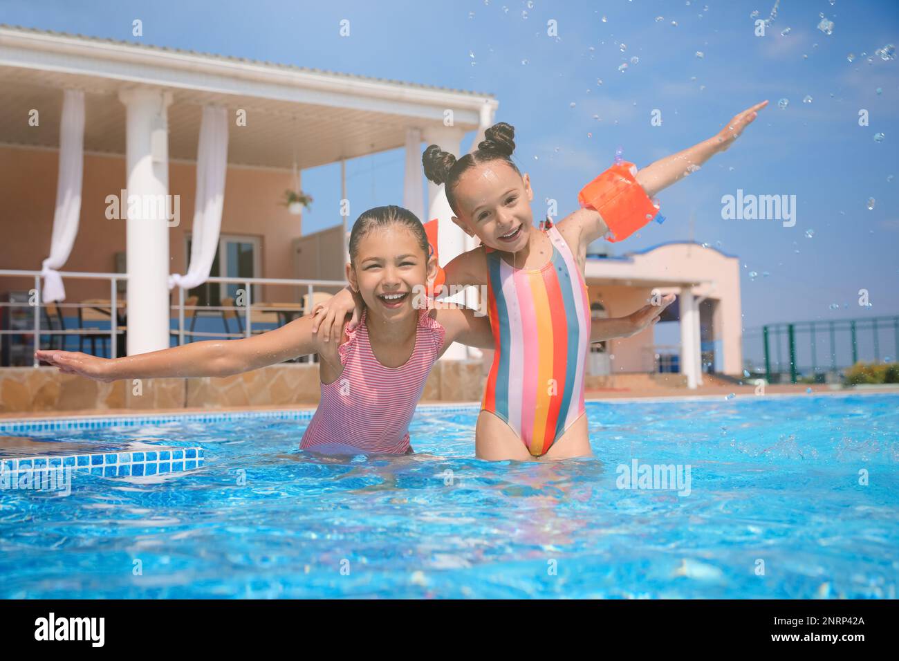 Cute little girls in swimming pool at water park Stock Photo - Alamy