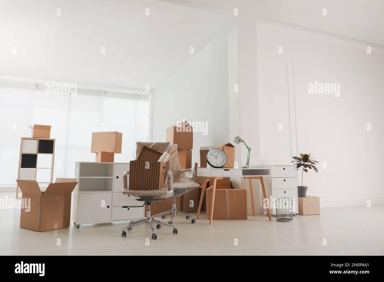 Cardboard boxes and packed stuff in office. Moving day Stock Photo - Alamy
