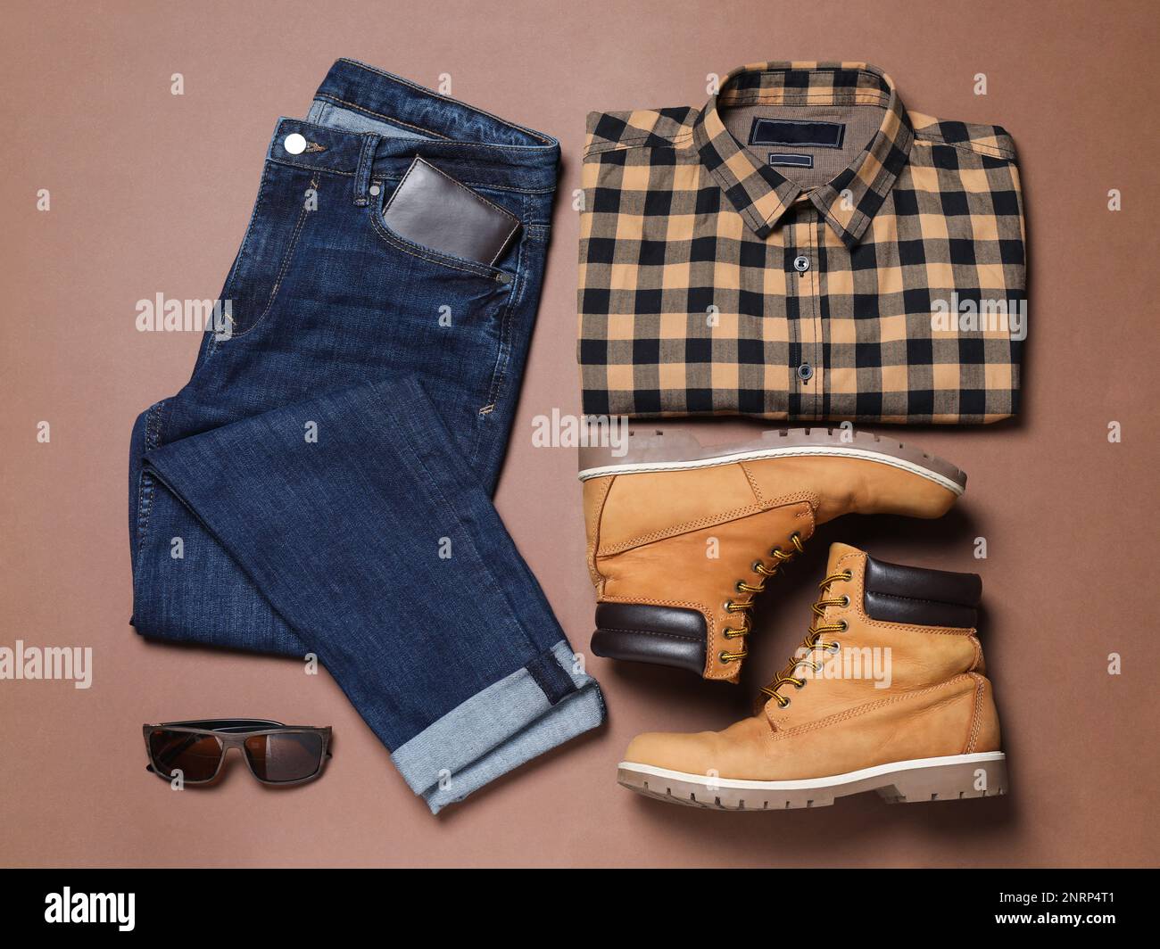 Flat lay composition with stylish men's clothes and boots on brown ...