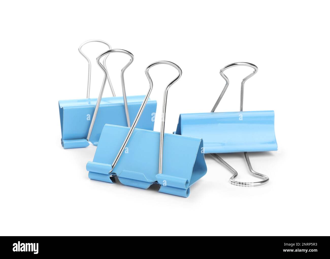 Light blue binder clips on white background. Stationery Stock Photo - Alamy