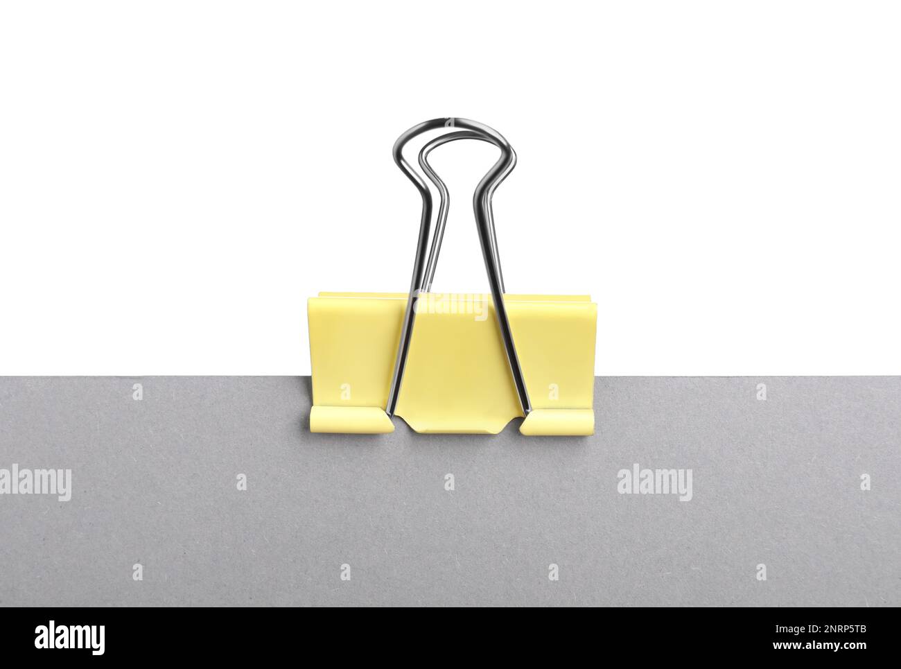 Grey paper with yellow binder clip isolated on white Stock Photo - Alamy