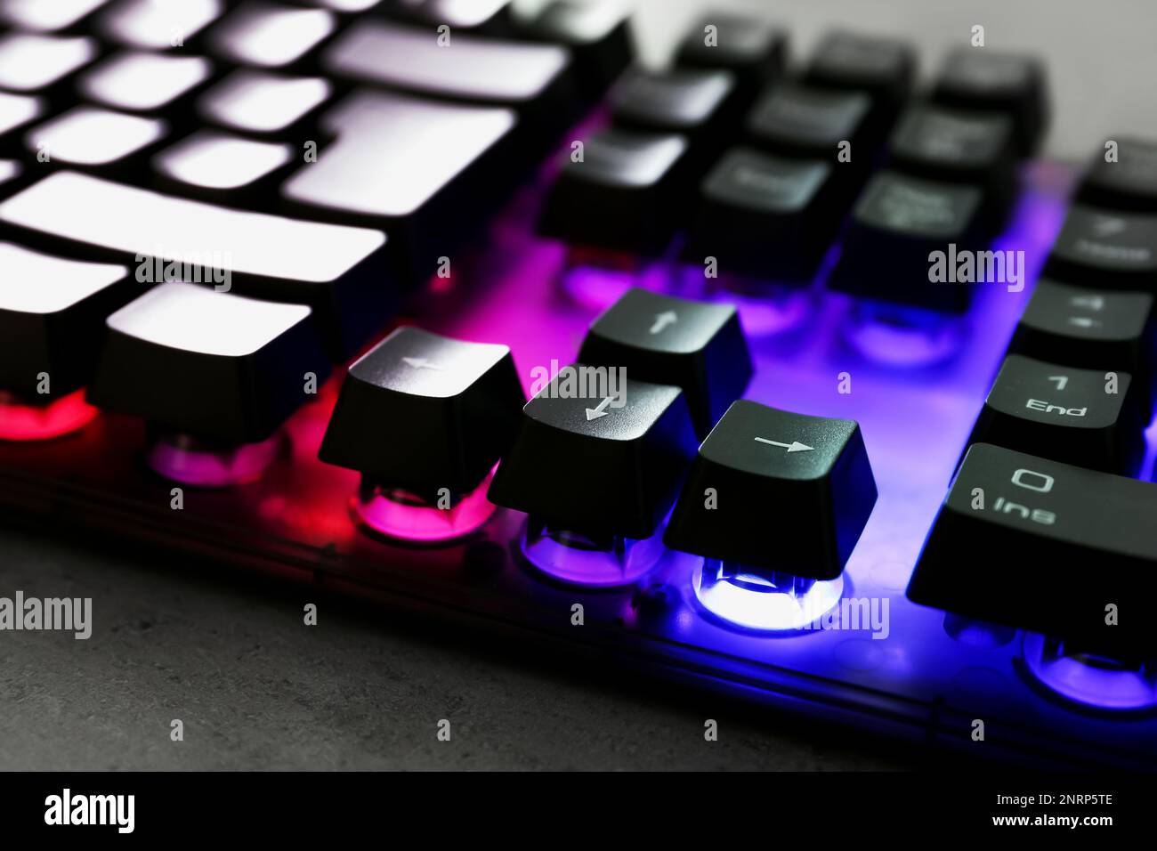 Modern keyboard with RGB lighting on grey table, closeup Stock Photo ...