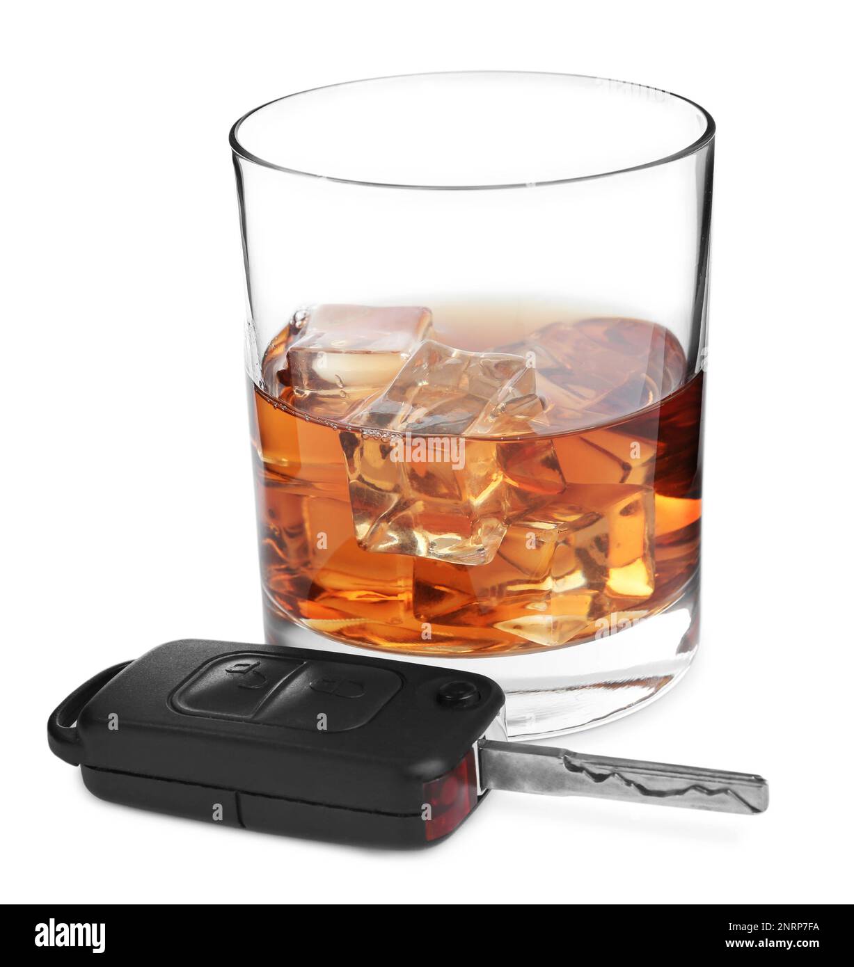 Glass of alcohol and car key on white background. Drunk driving concept ...