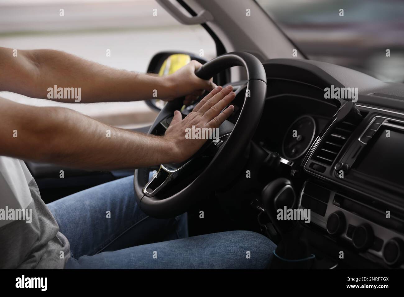 Man pressing horn in car, closeup. Aggressive driving behavior Stock ...