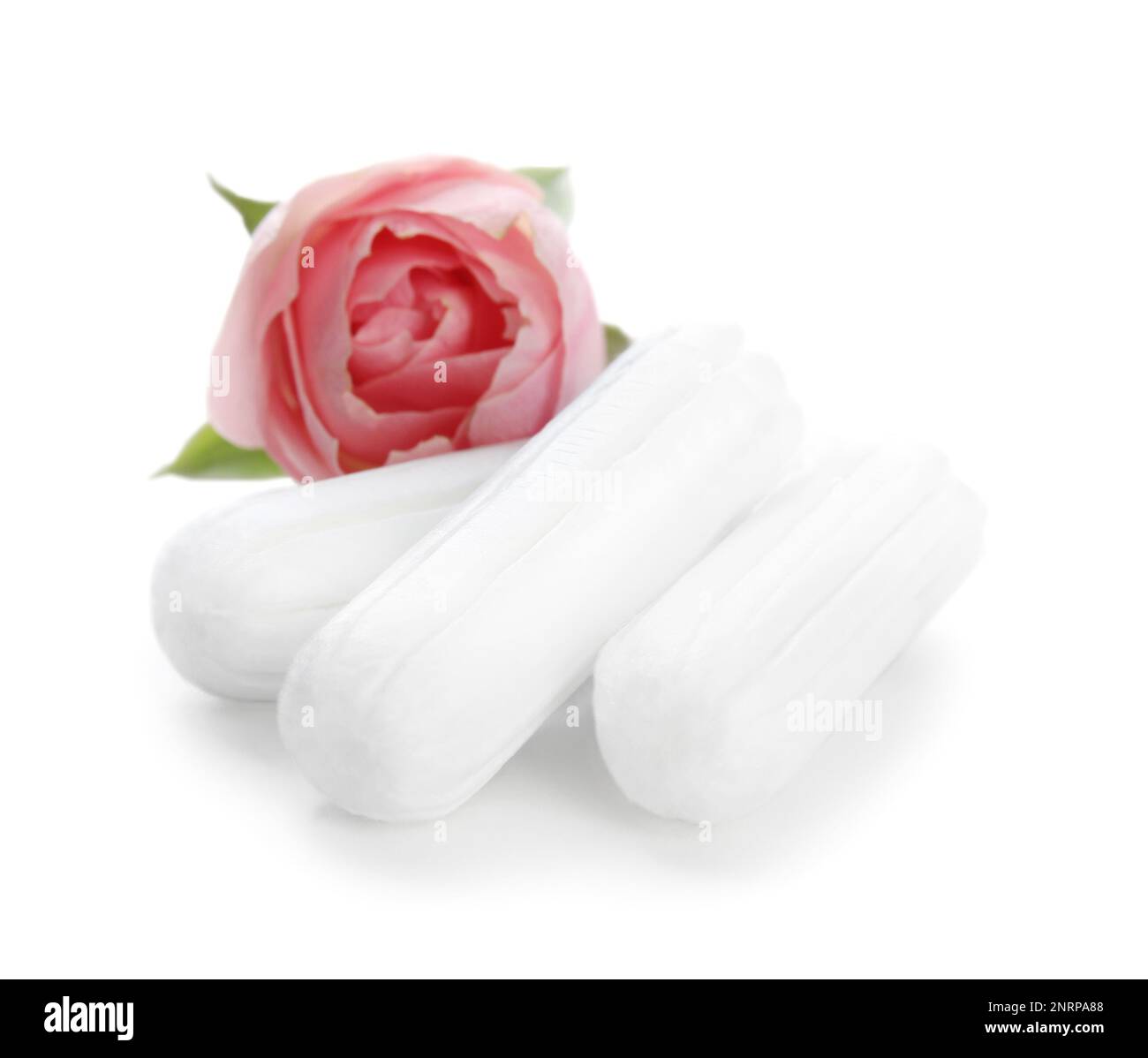 Tampons and beautiful rose on white background Stock Photo - Alamy