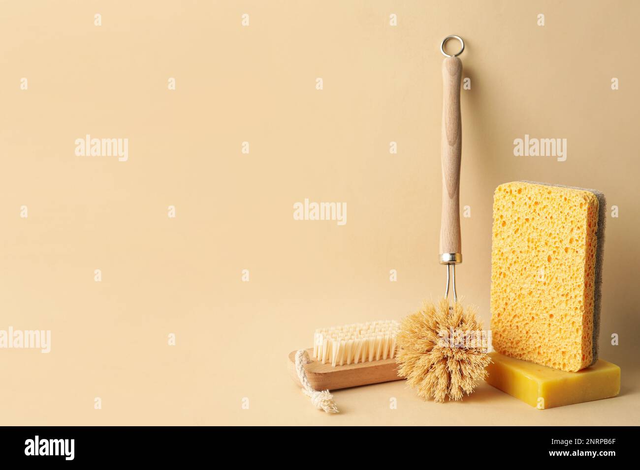 Set of eco friendly cleaning supplies for washing dishes on beige ...