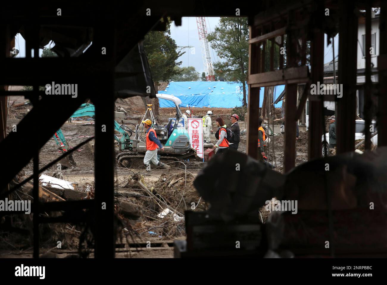 Volunteers walk at a disaster stricken are in Nagano, Nagano prefecture ...
