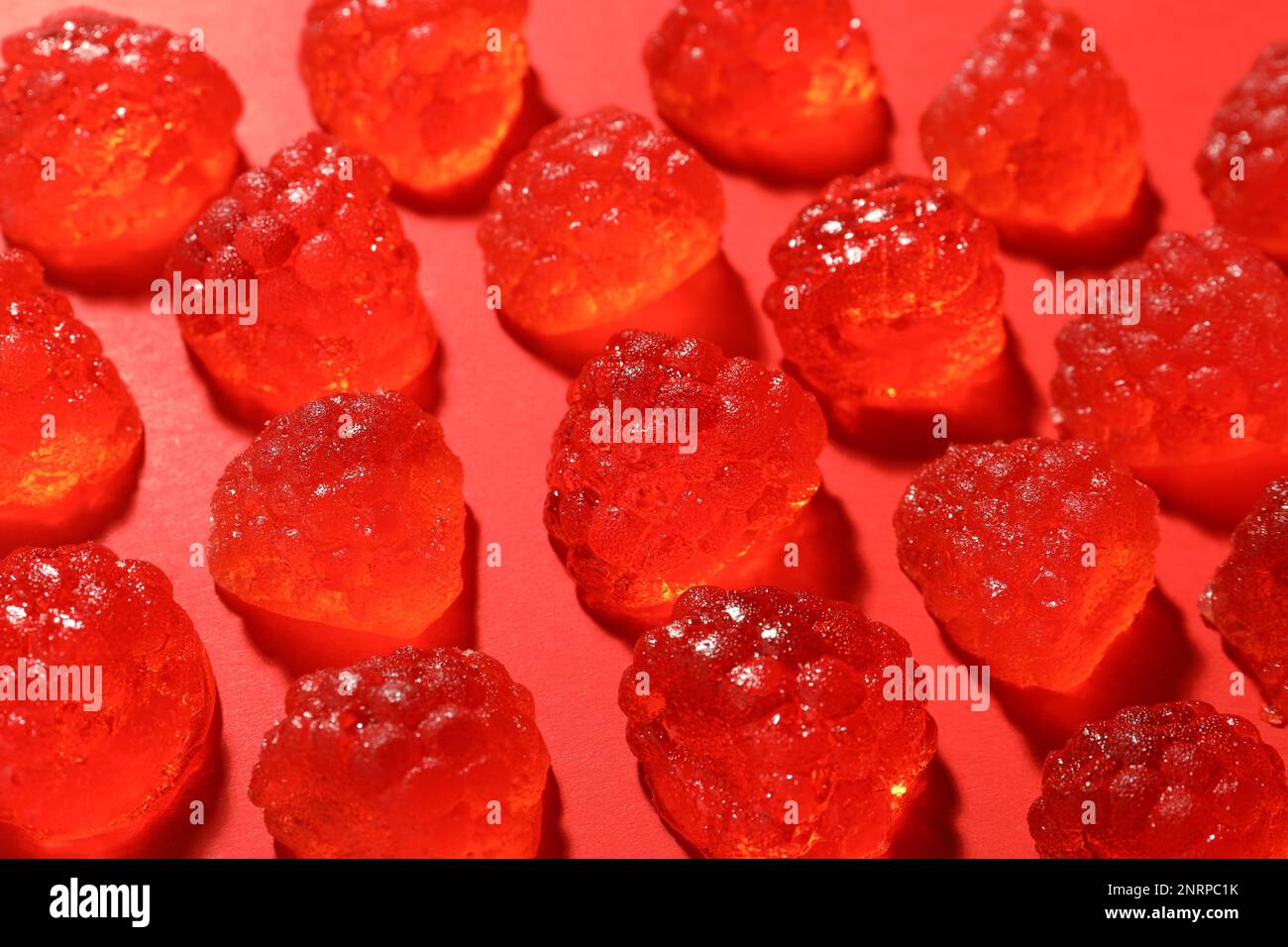 Delicious gummy raspberry candies on red background, closeup Stock ...