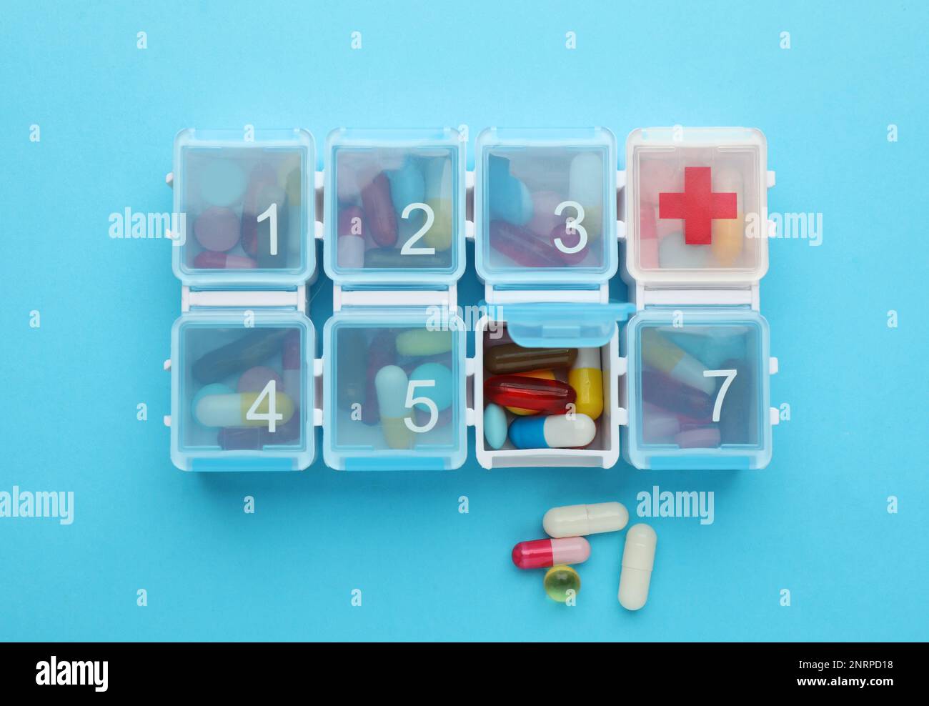 Pill box with medicaments on light blue background, flat lay Stock ...