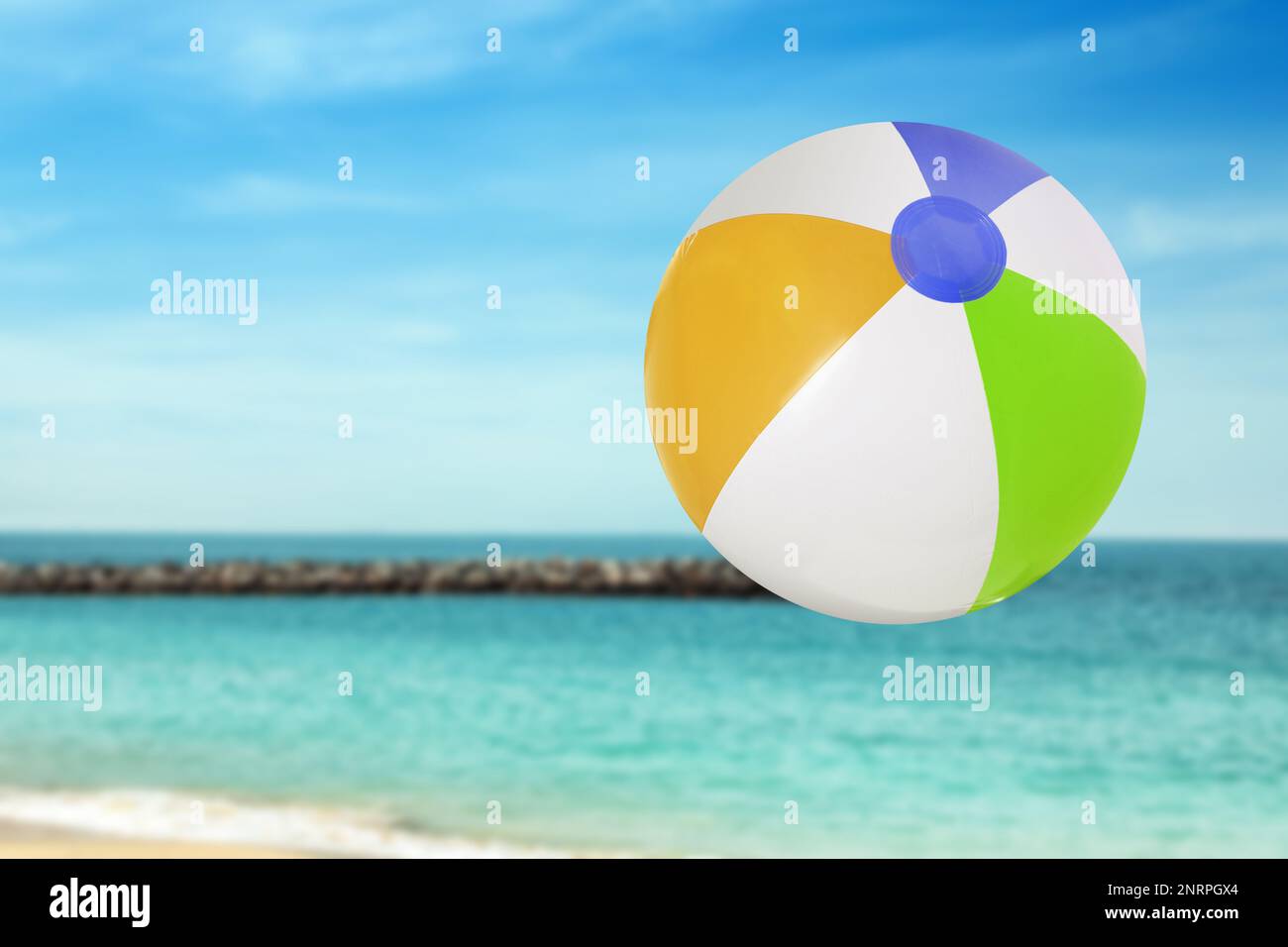 Colorful inflatable beach ball and seascape on background Stock Photo ...