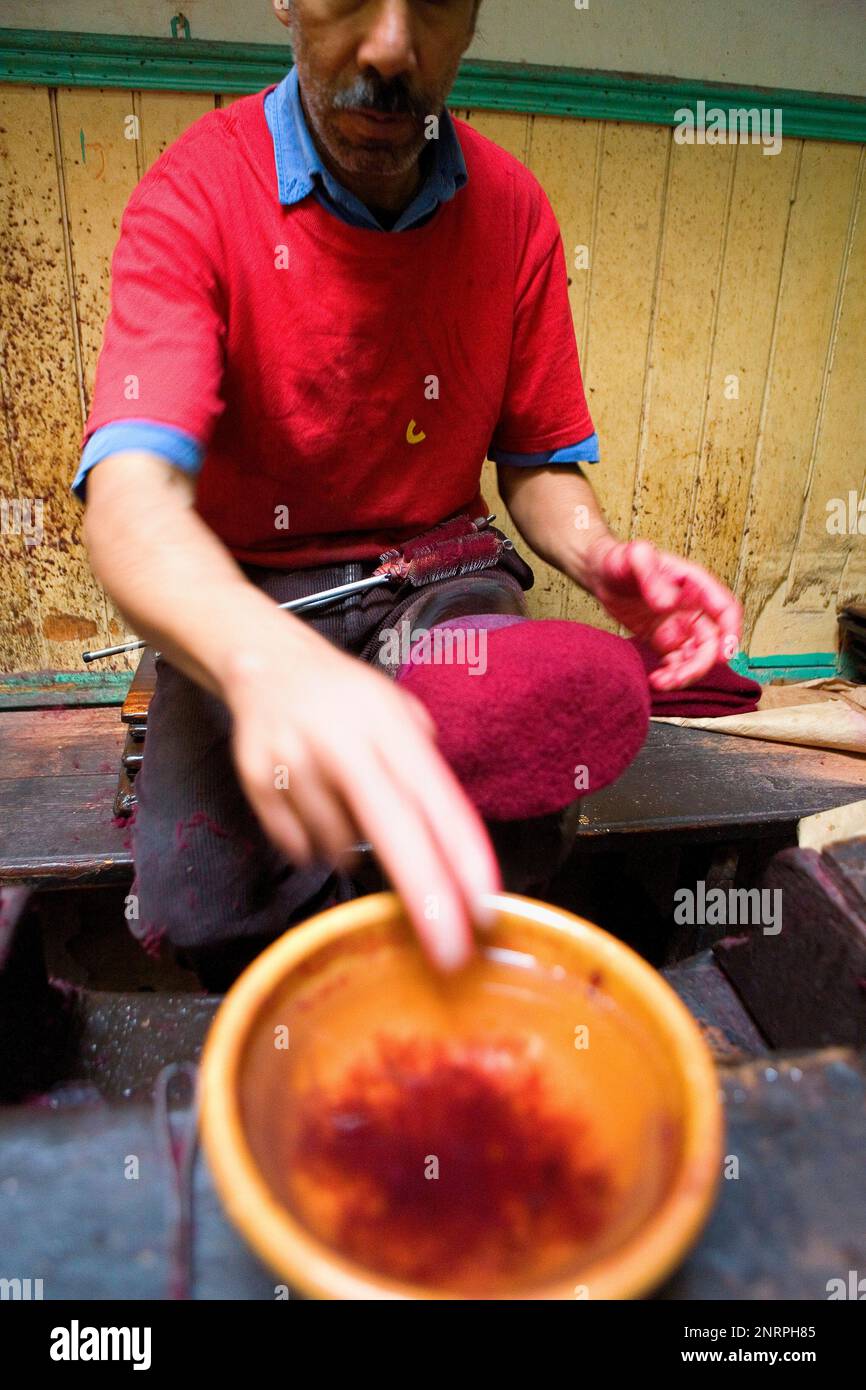 Tunisia: City of Tunis.Medina.Making traditional caps of red color ...