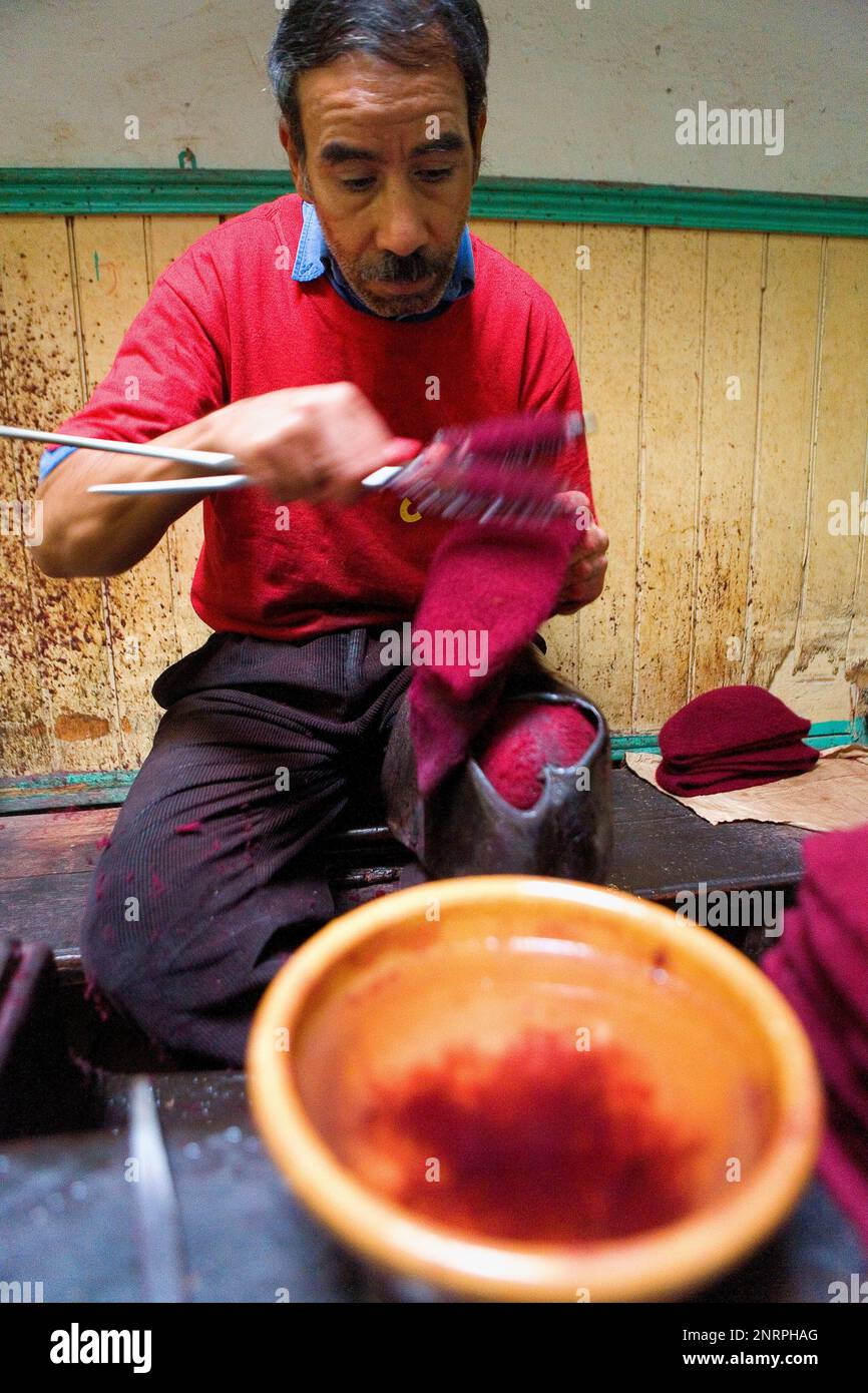 Tunisia: City of Tunis.Medina.Making traditional caps of red color ...