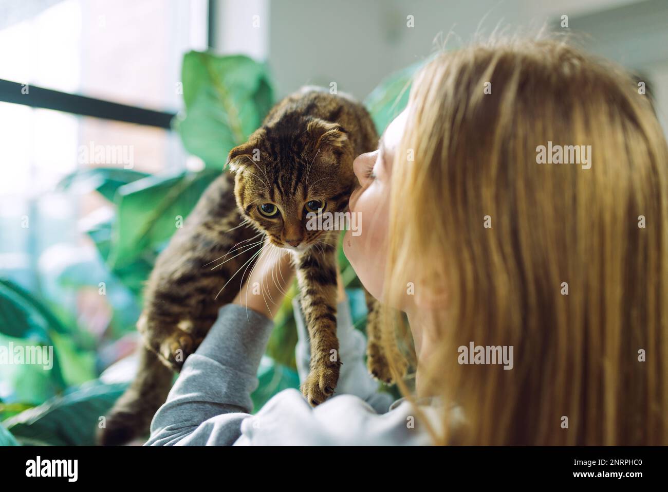 Casual Young Blonde Woman Holds Shoulder a Cute Green-eyed Scottish ...