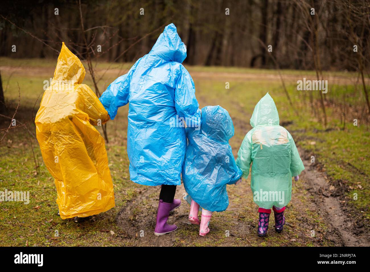 Children in raincoats walking in rain hi-res stock photography and ...