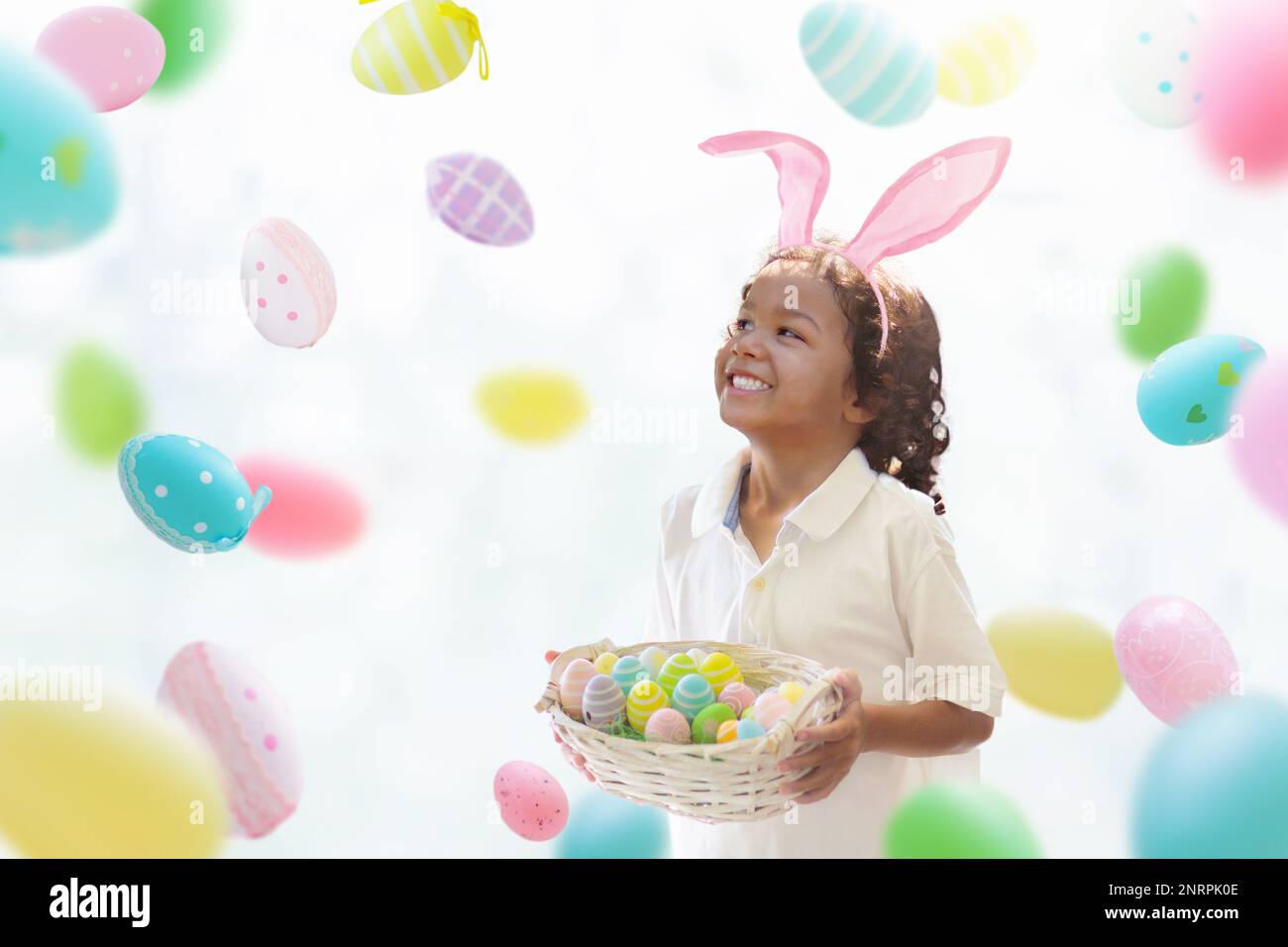 Kids dyeing Easter eggs. Children in bunny ears dye colorful egg for ...