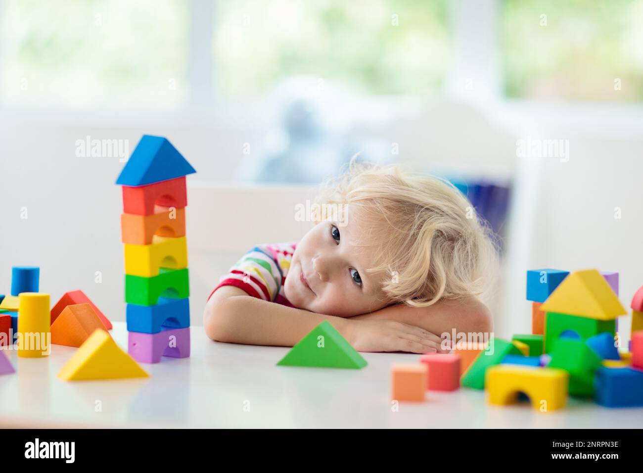 Kid playing with colorful toy blocks. Little boy building tower of ...