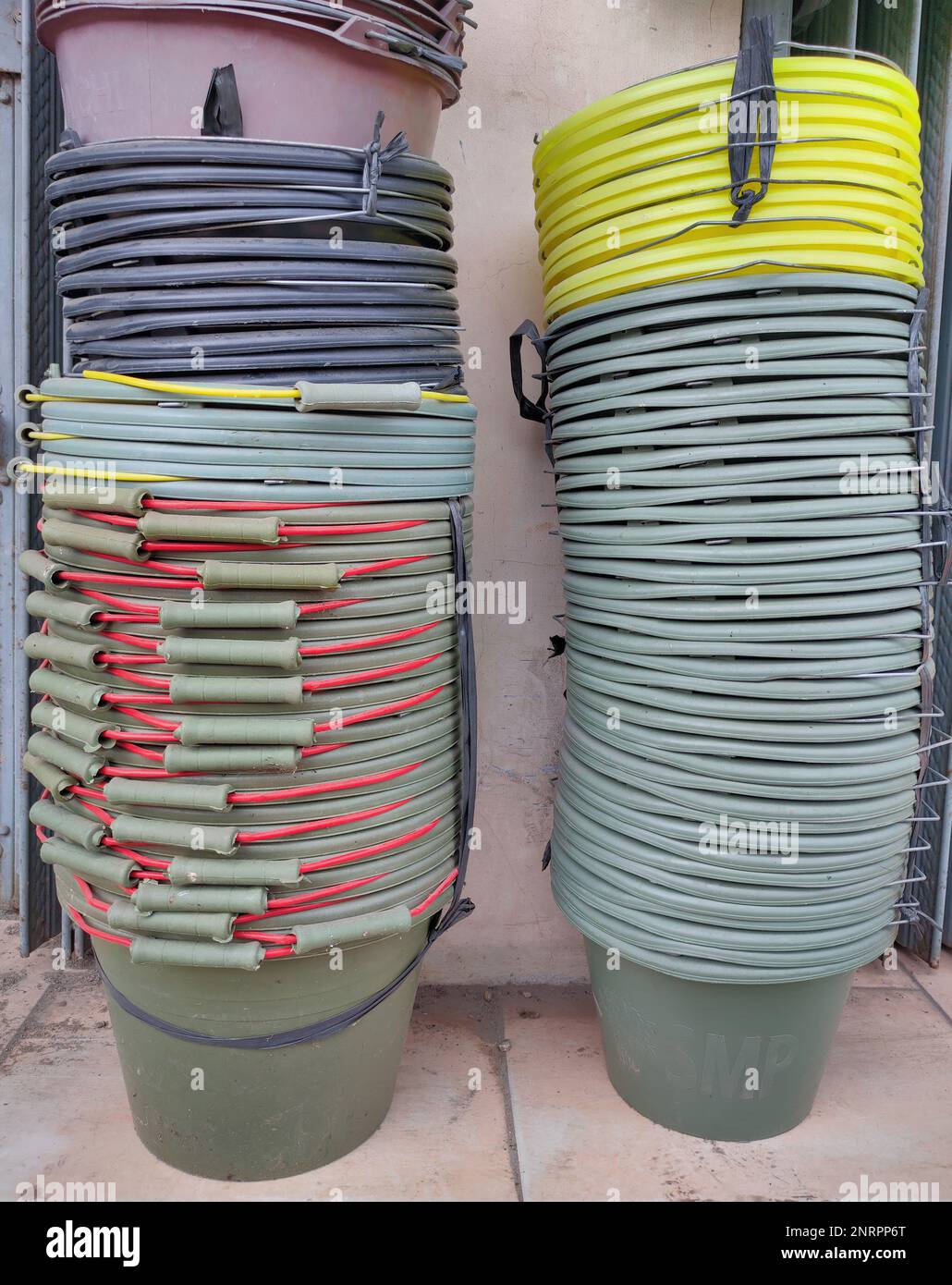 This arrangement of piles of buckets of various colors that will later ...