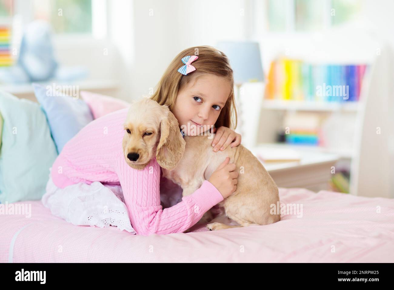 Child playing with baby dog. Kids play with puppy. Little girl and ...