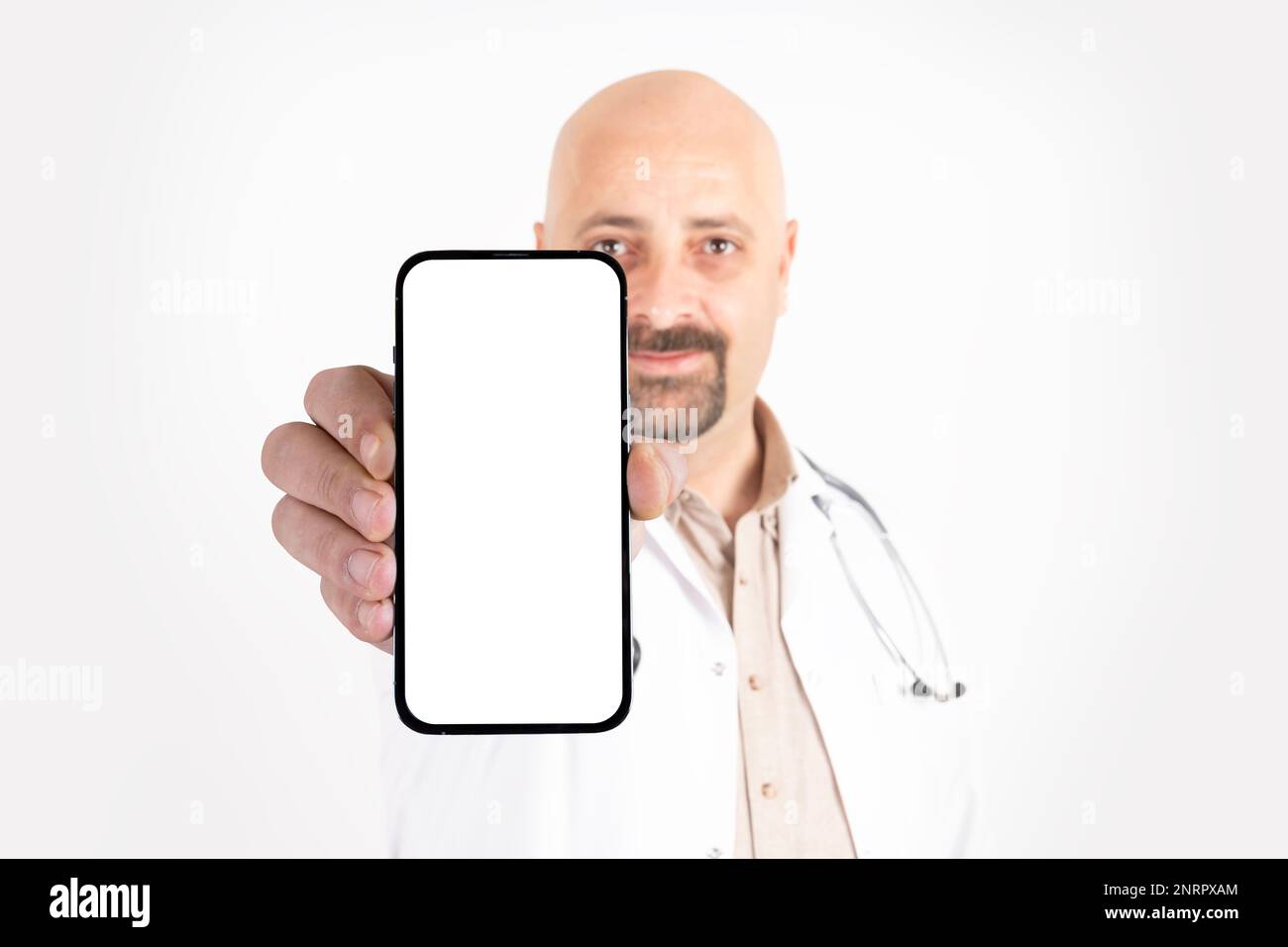 Caucasian male doctor showing smartphone. Big blank empty white screen ...