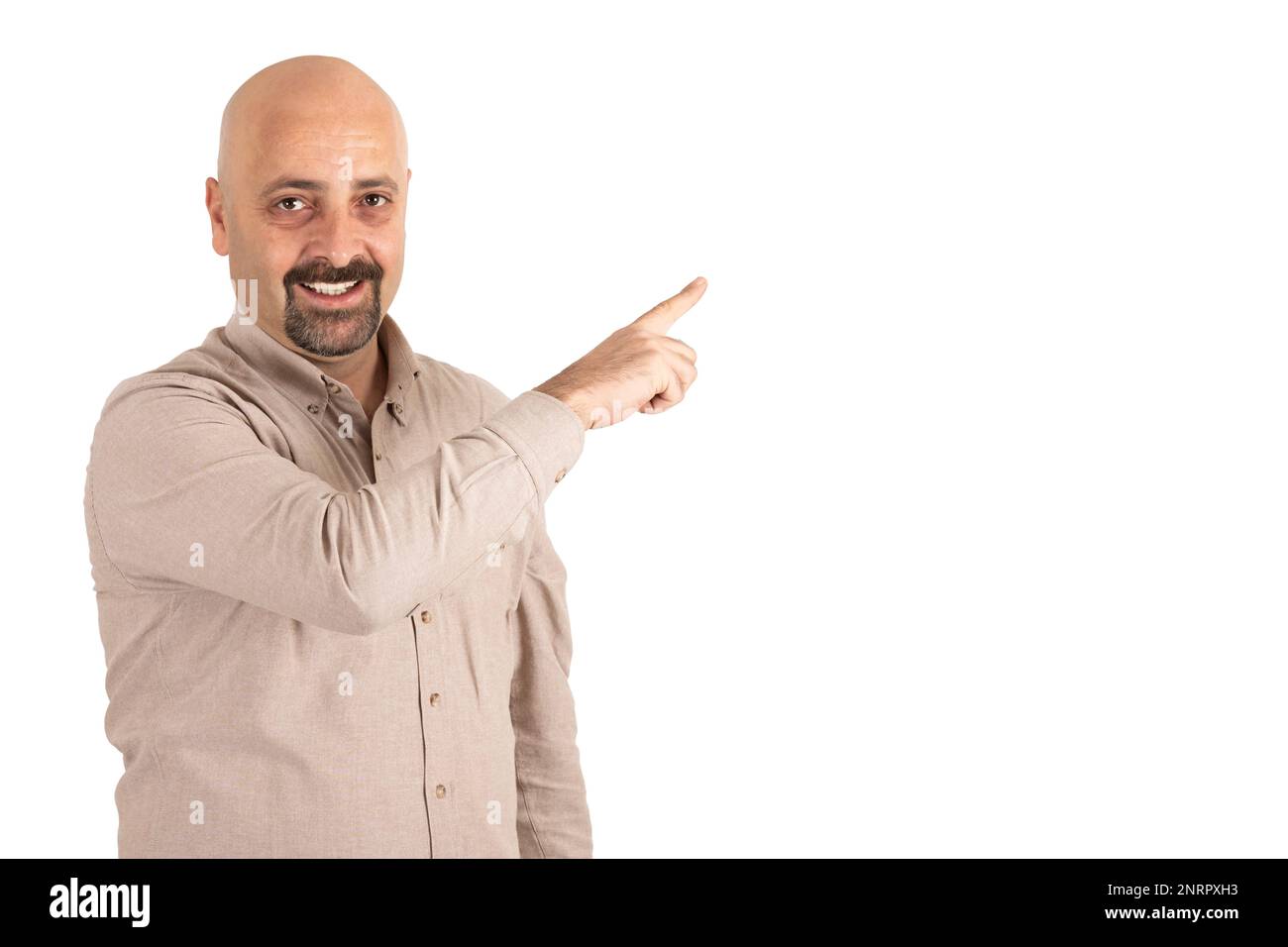 Pointing away, portrait of caucasian bald male pointing away. Happy ...